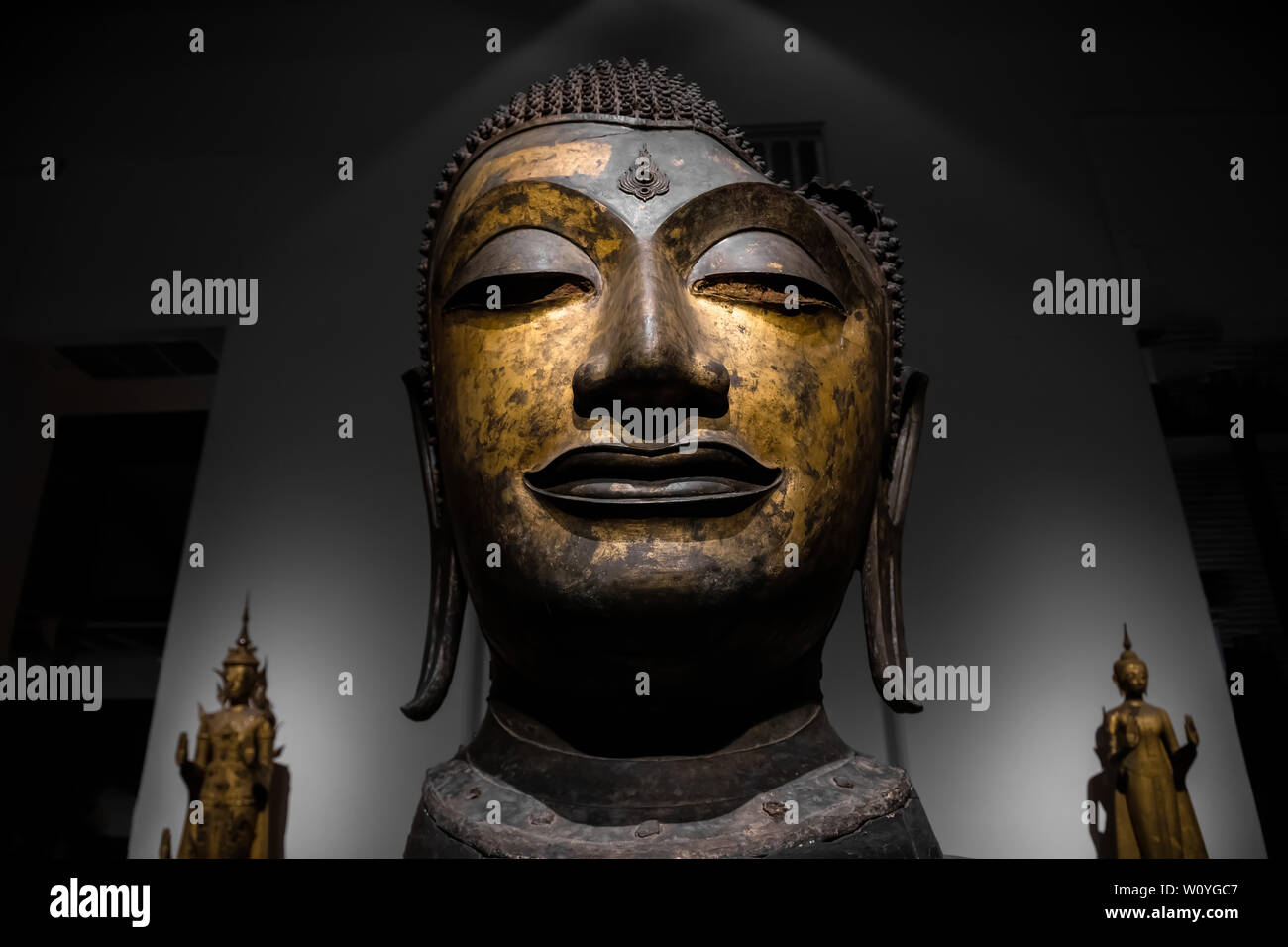 Golden Buddha head statue ancient art of Thailand from Bangkok with low ...