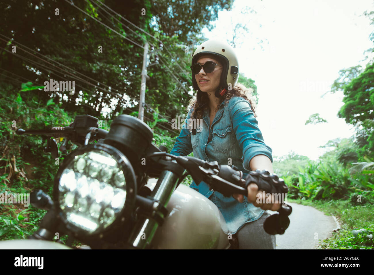 Beautiful female biker driving a cafe' racer motorbike - Pretty girl ...
