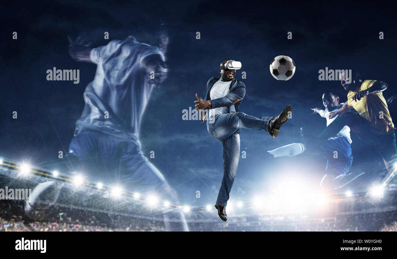 Virtual Reality headset on a black male playing football Stock Photo ...