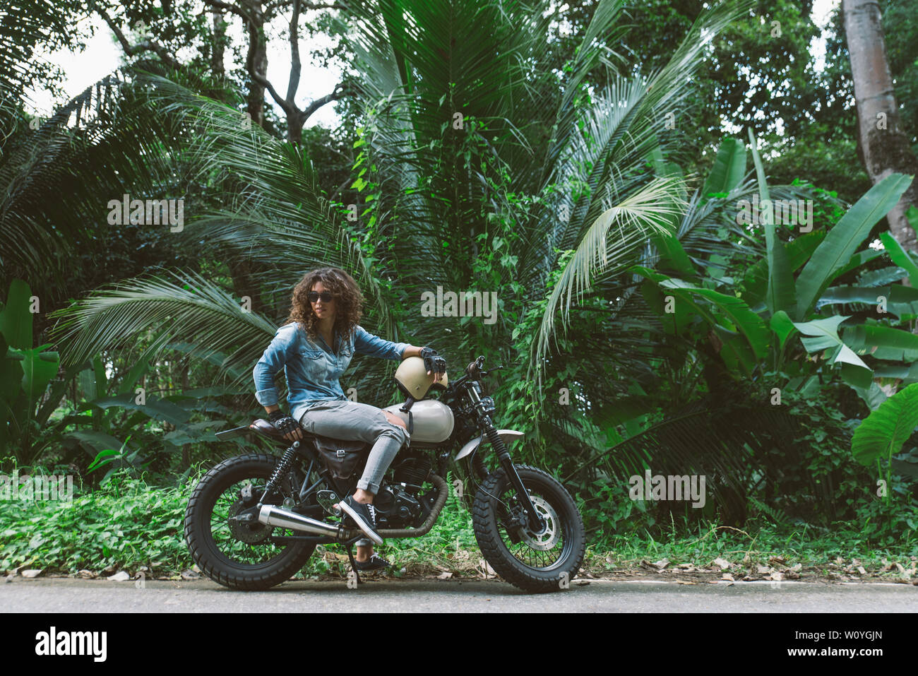 Beautiful female biker driving a cafe' racer motorbike - Pretty girl ...