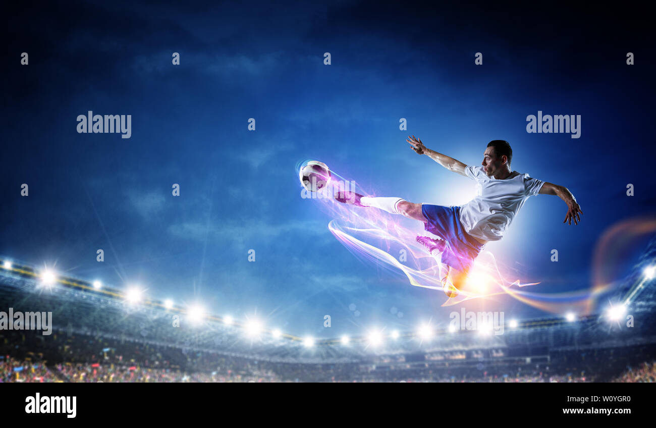 Football player on stadium. Mixed media Stock Photo - Alamy