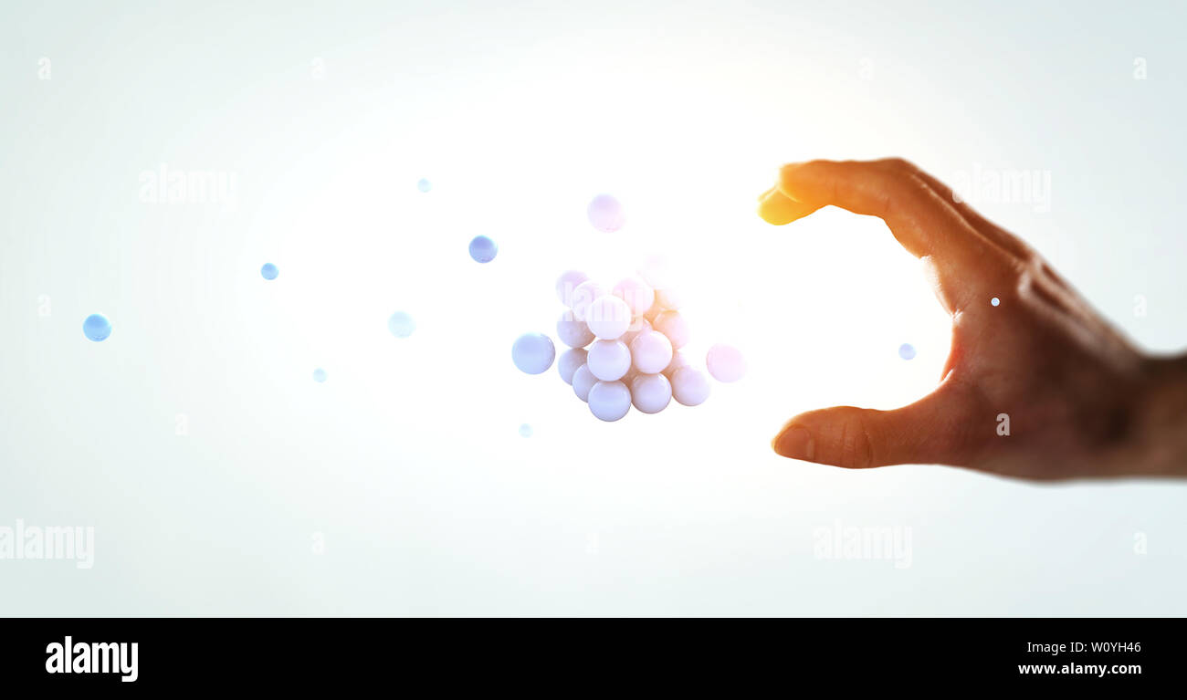 Female hand and a bunch of colourful spheres levitating above. Mixed ...