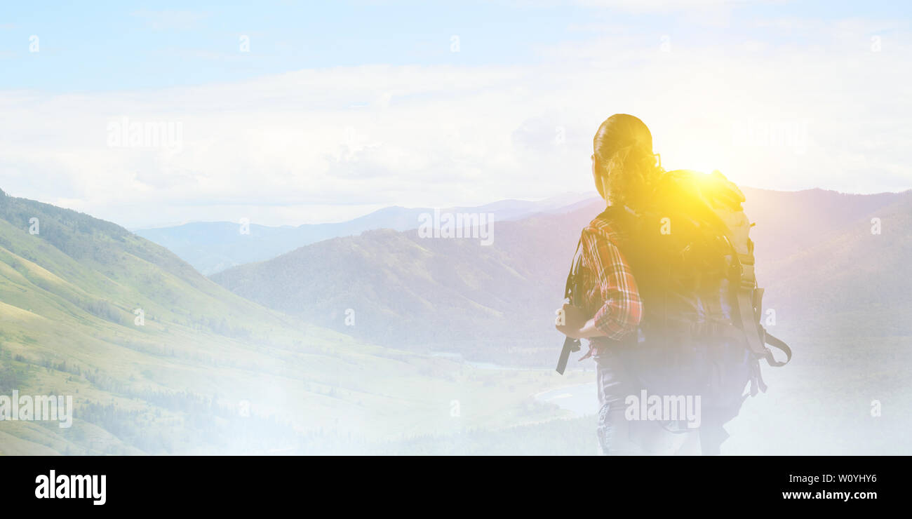 Back view of young woman with backpack Stock Photo - Alamy