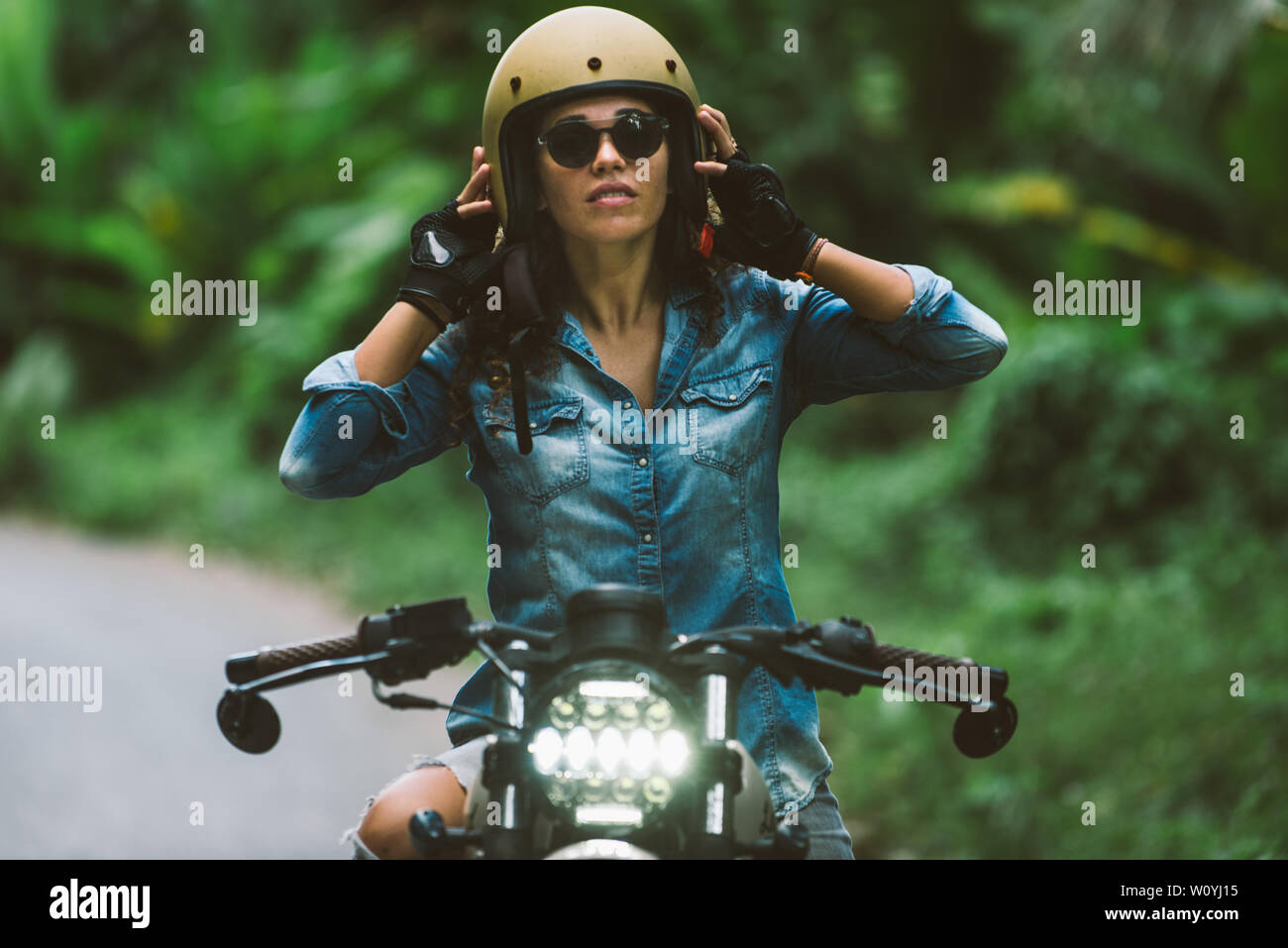 Beautiful female biker driving a cafe' racer motorbike - Pretty girl ...