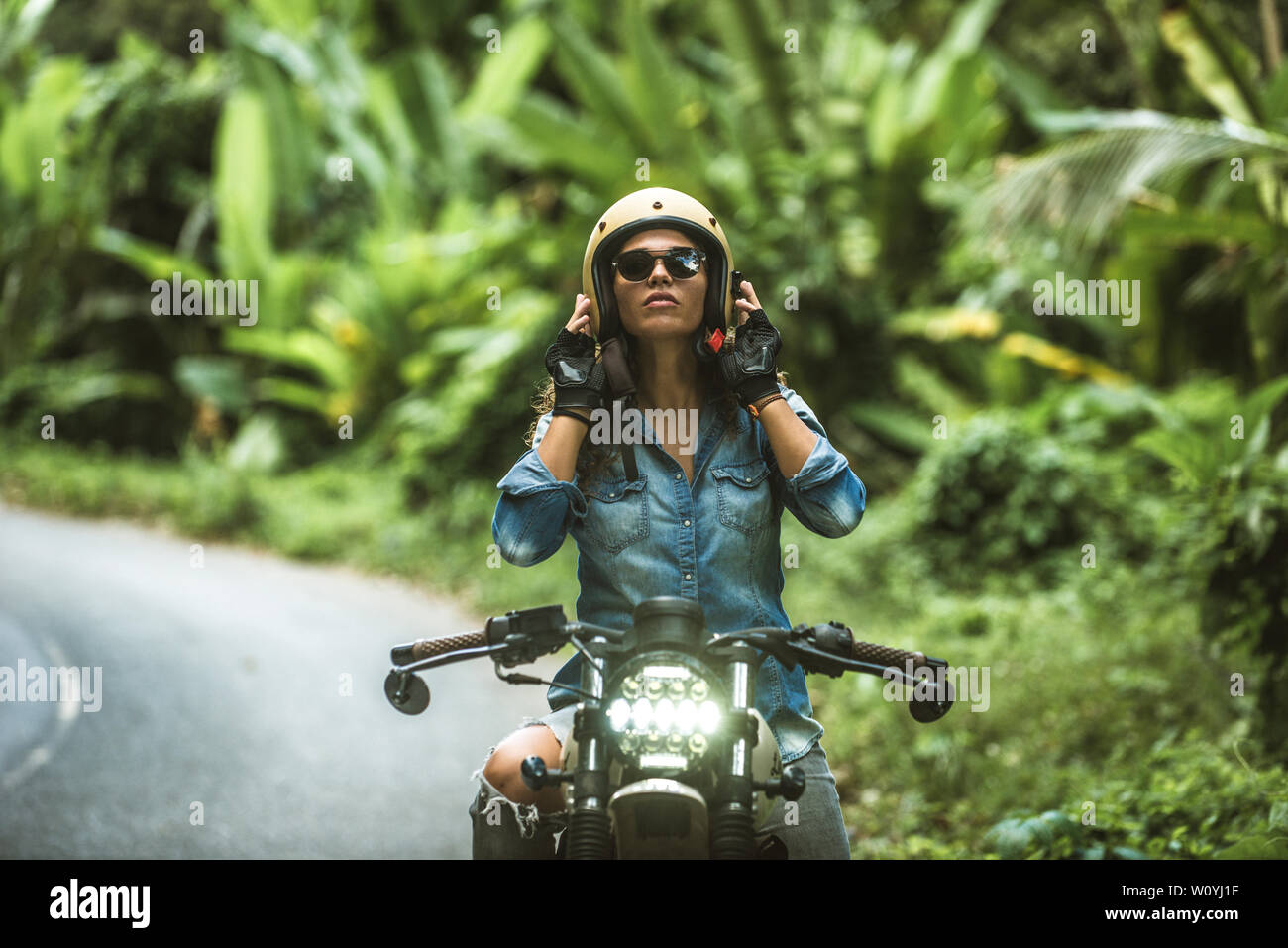 Beautiful female biker driving a cafe' racer motorbike - Pretty girl ...