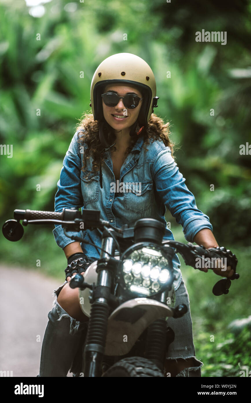 Beautiful female biker driving a cafe' racer motorbike - Pretty girl ...