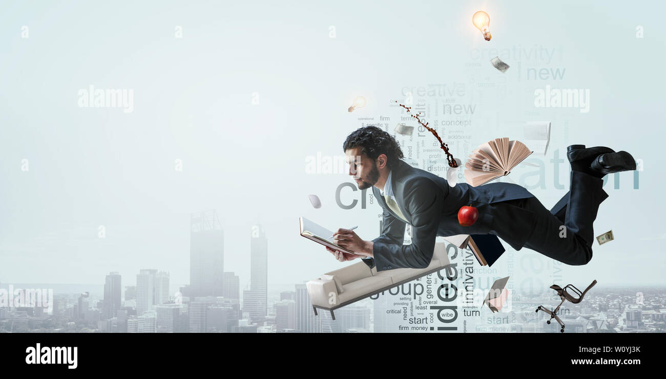 Young businessmen at work, lying horizontally with notebook, office ...
