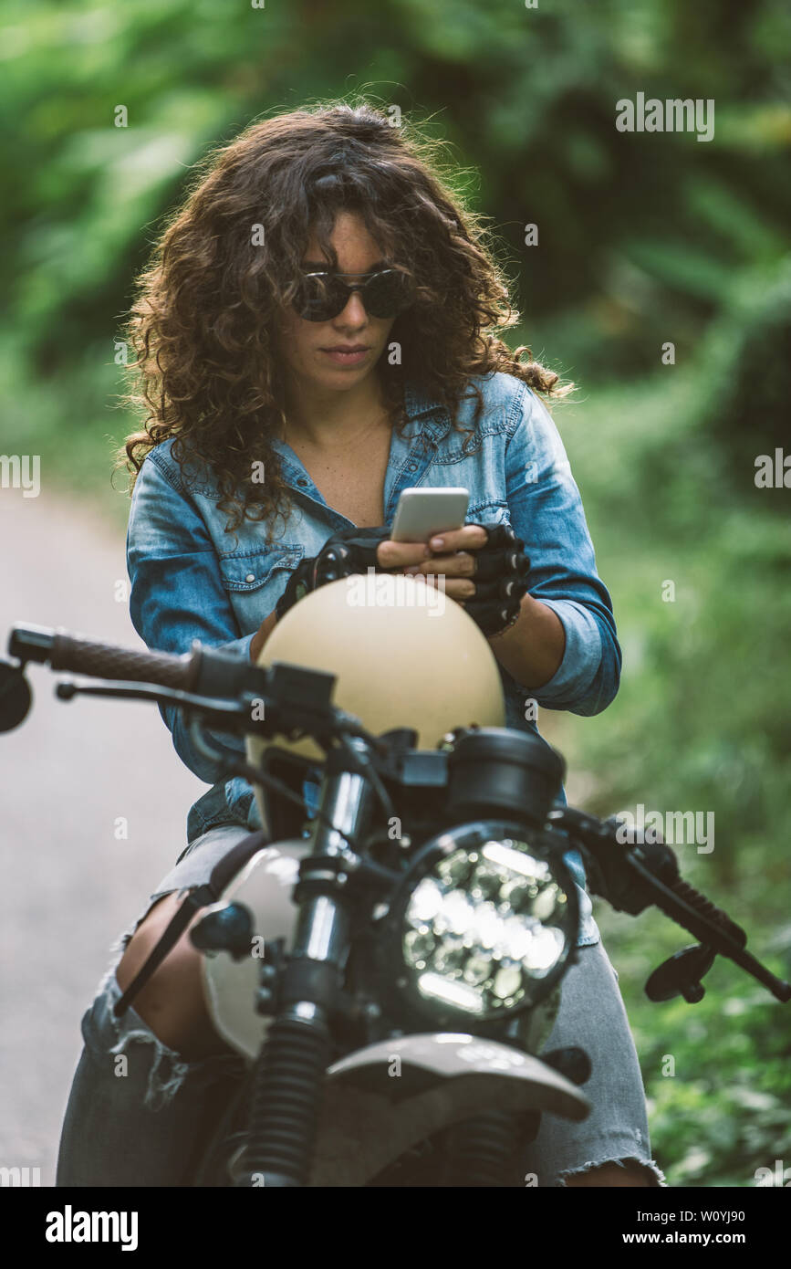 Beautiful female biker driving a cafe' racer motorbike - Pretty girl ...