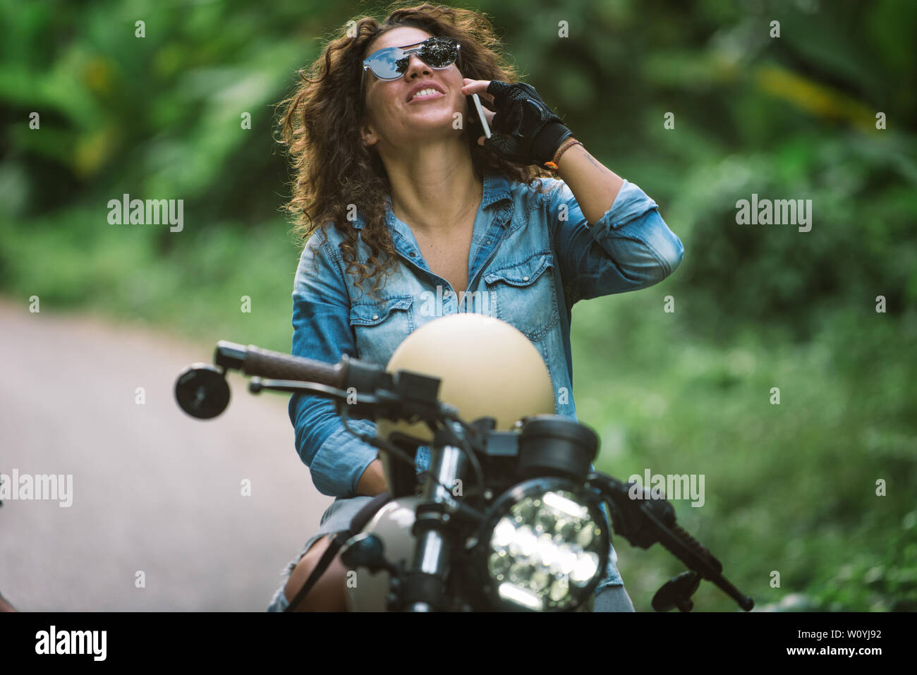 Beautiful female biker driving a cafe' racer motorbike - Pretty girl ...