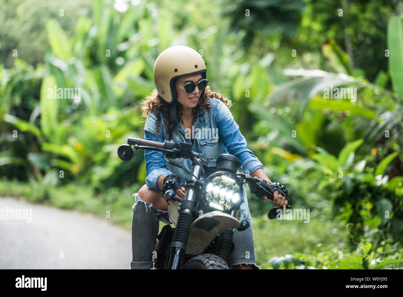 Beautiful female biker driving a cafe' racer motorbike - Pretty girl ...