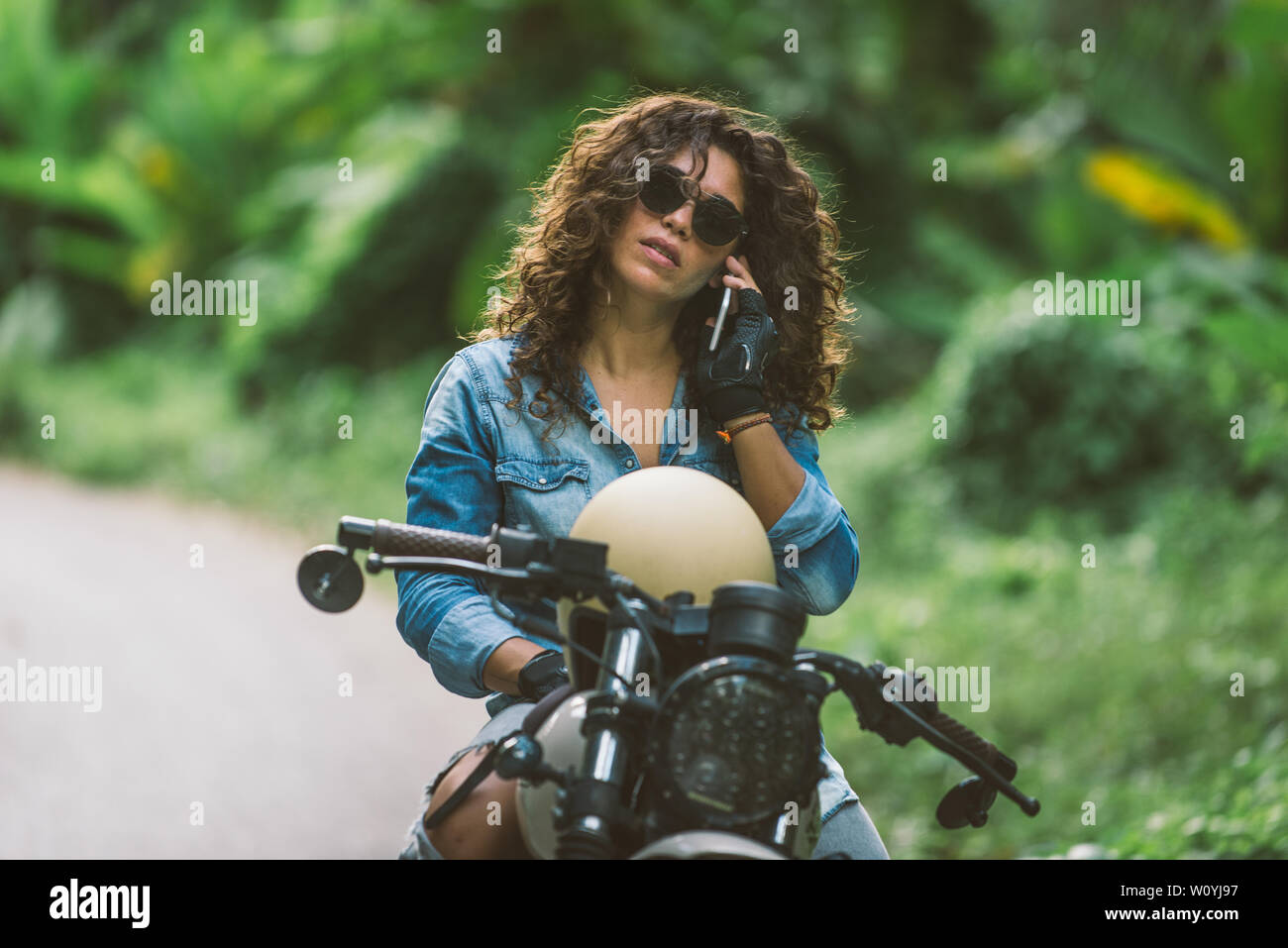 Beautiful female biker driving a cafe' racer motorbike - Pretty girl ...