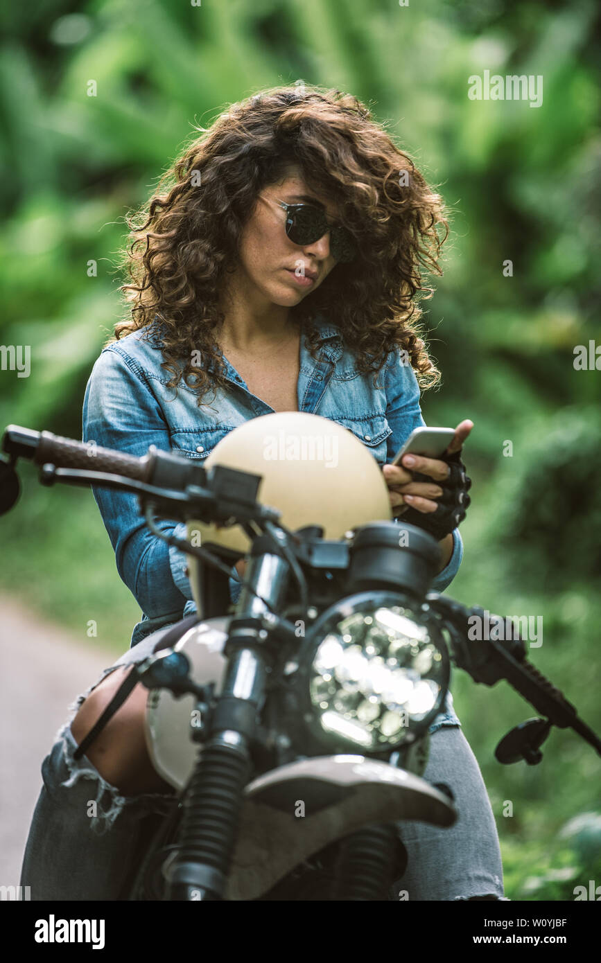 Beautiful female biker driving a cafe' racer motorbike - Pretty girl ...