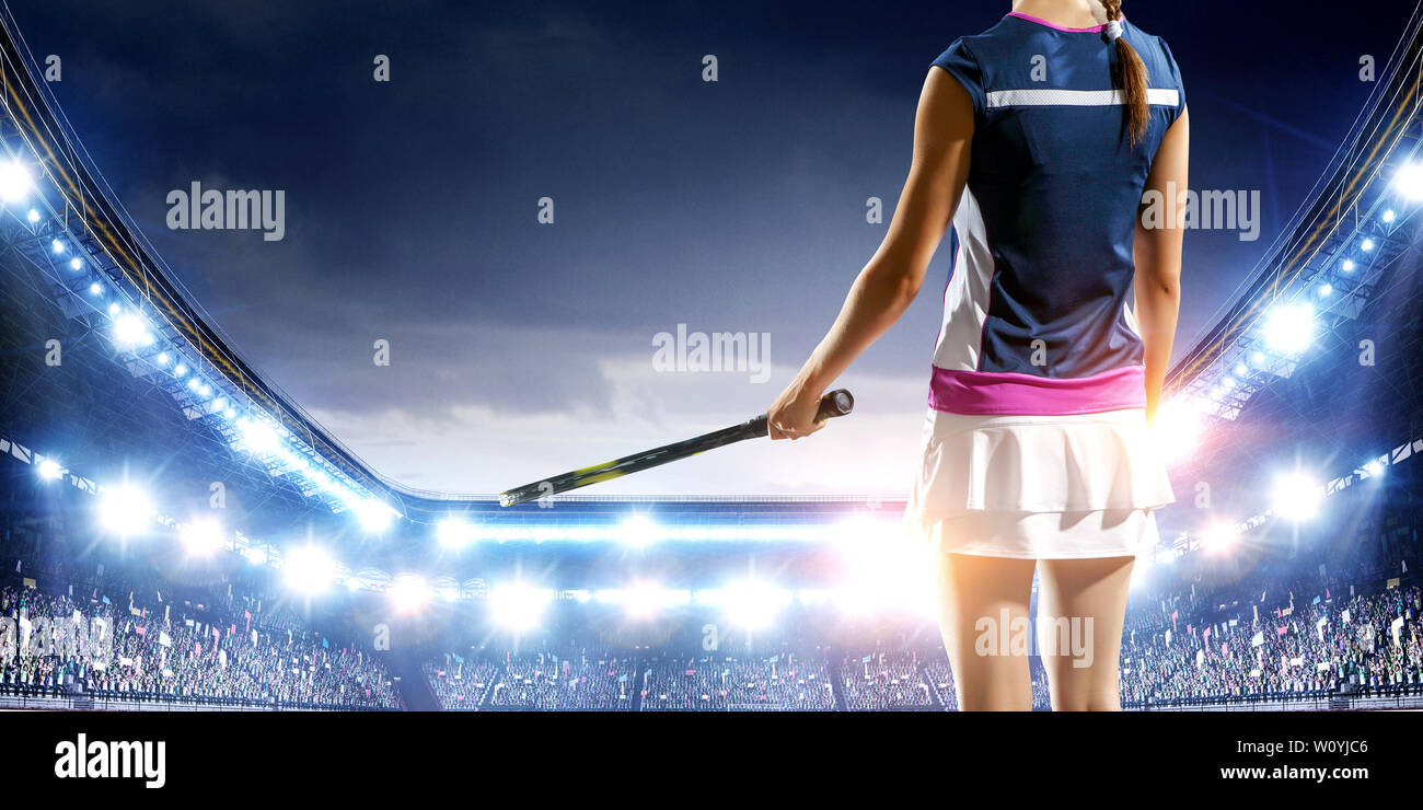 Back view of young woman in uniform standing on arena with racket Stock ...
