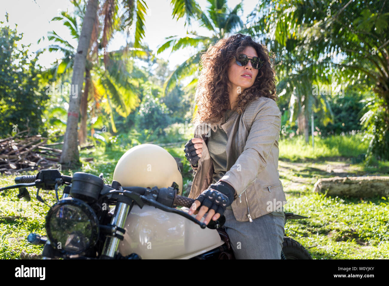 Beautiful female biker driving a cafe' racer motorbike - Pretty girl ...