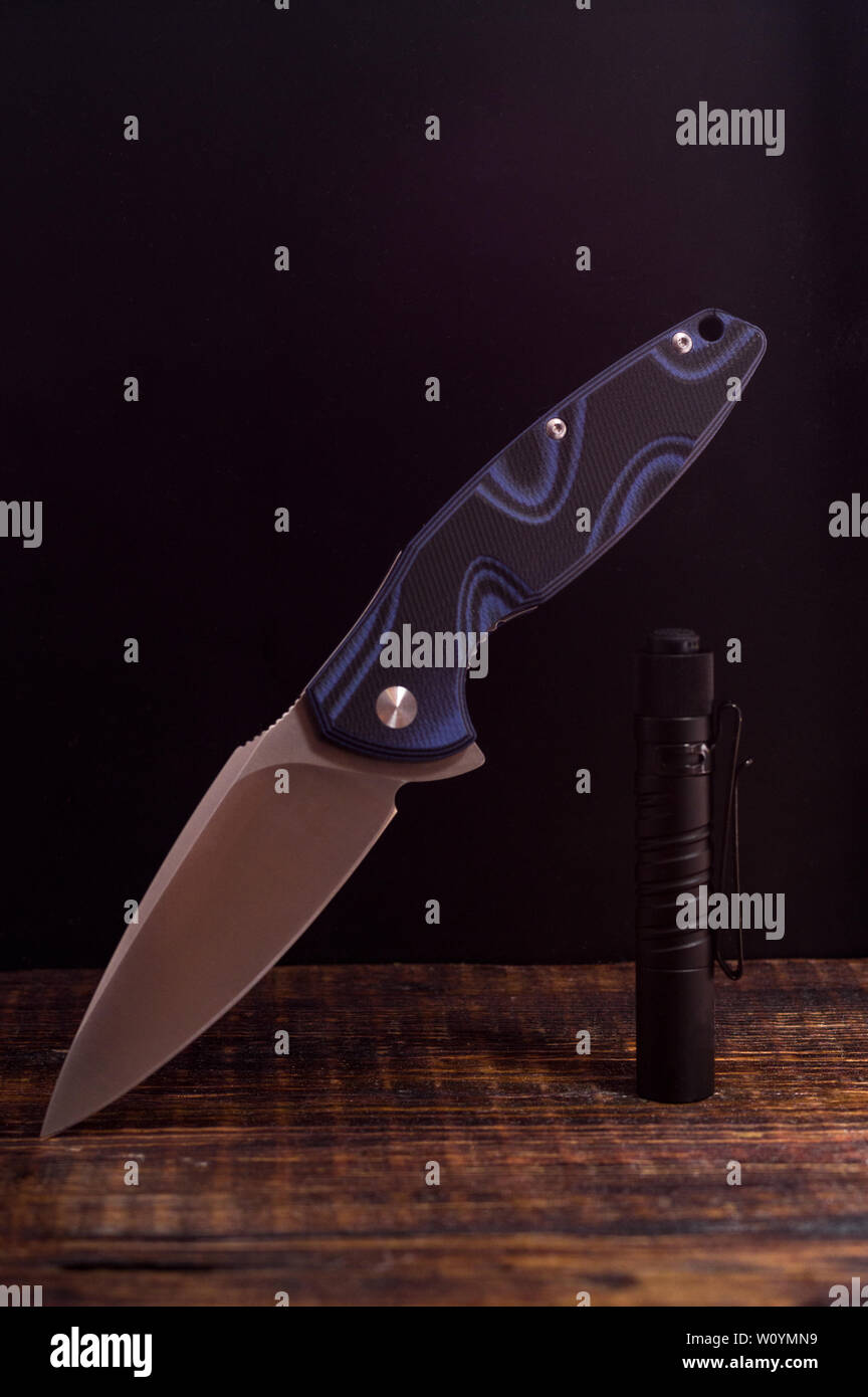 Knife in the unfolded form. The knife is in a hanging position.Vertical ...