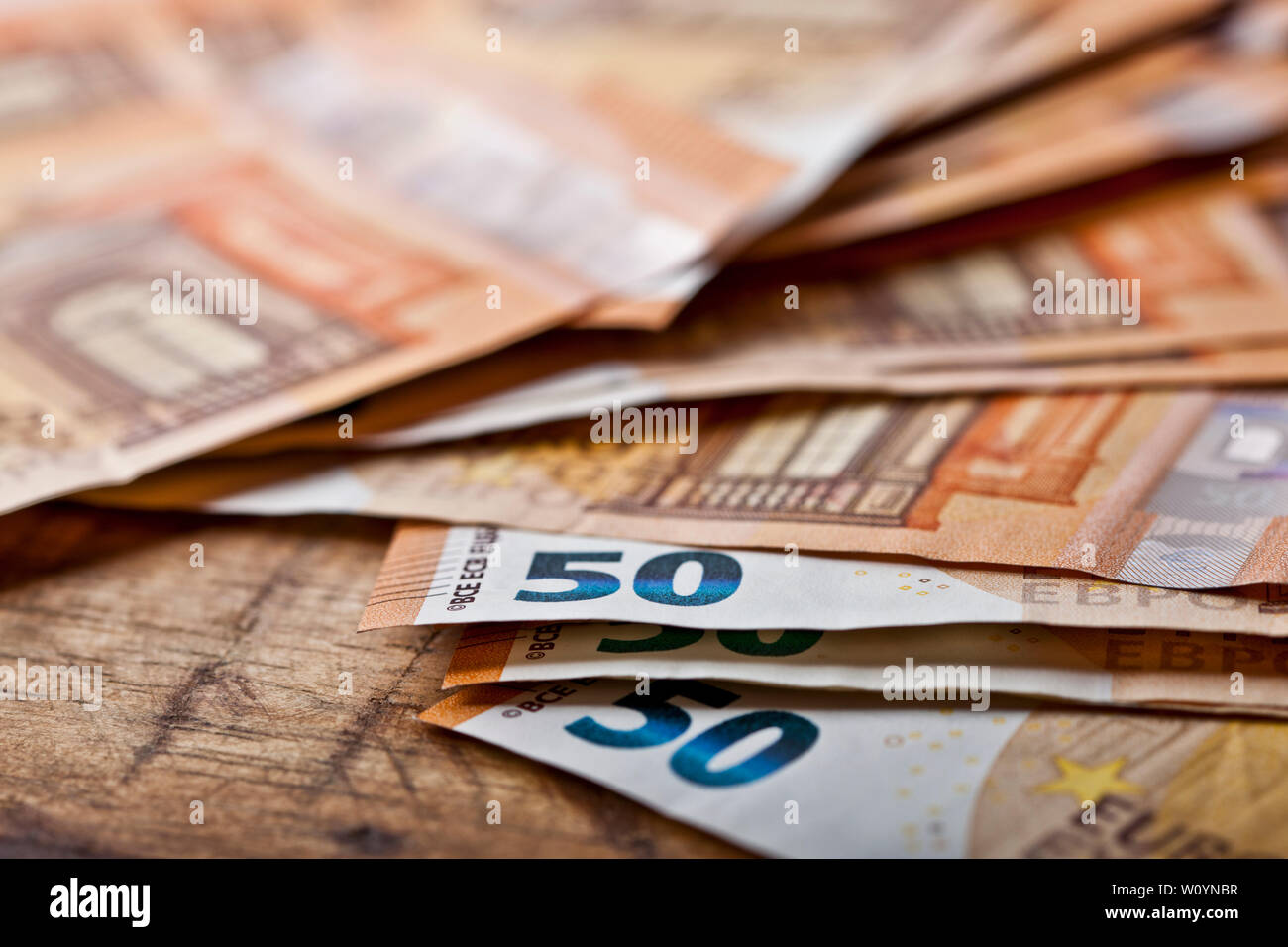 Pile of fifty euro banknotes. Currency bank notes stacked on rustic ...