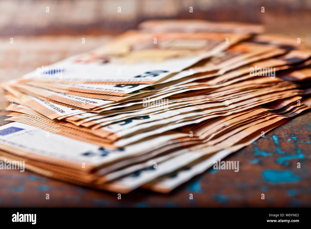 Pile of fifty euro banknotes. Currency bank notes stacked on rustic ...