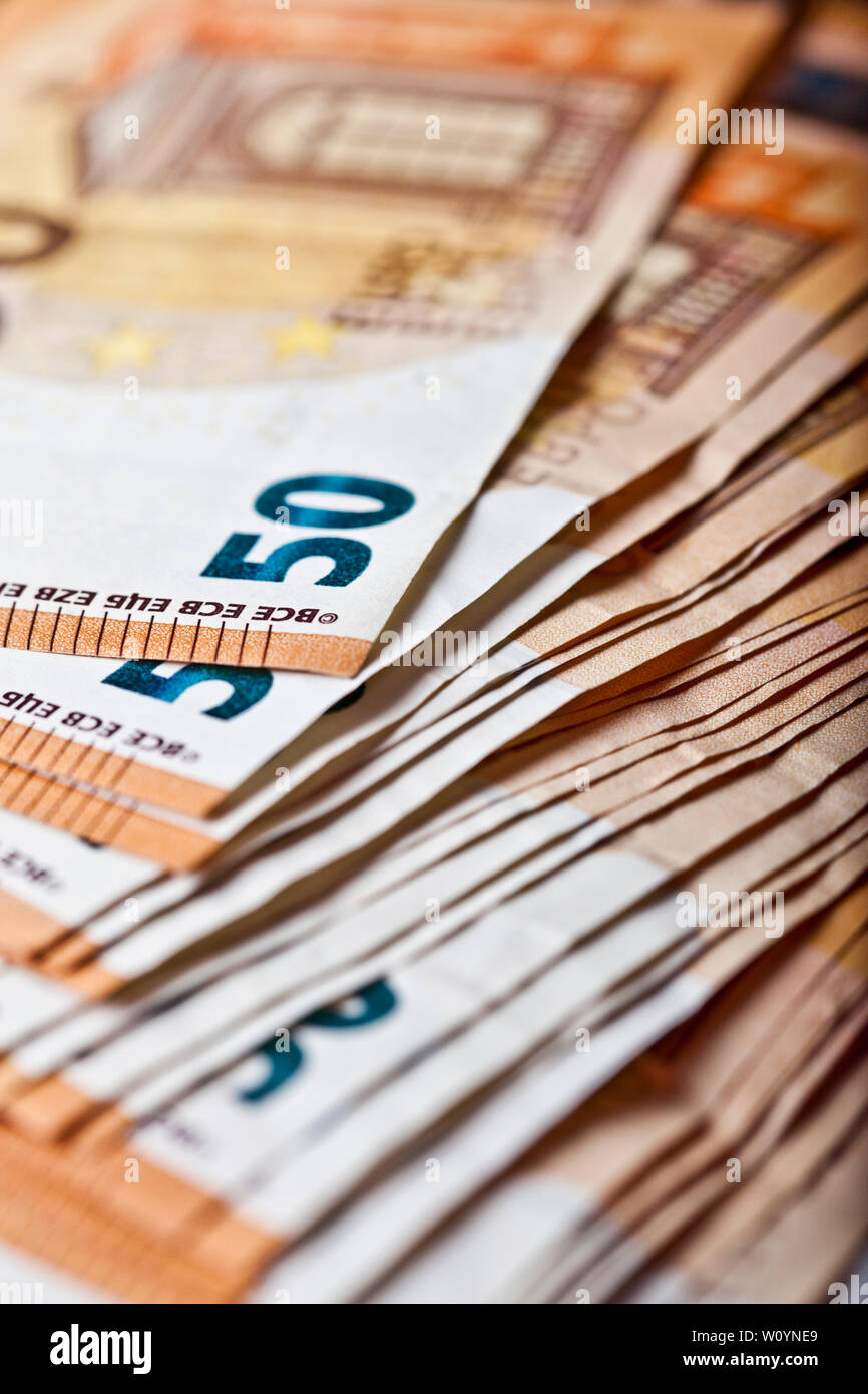 Pile of fifty euro banknotes. Currency bank notes stacked on rustic ...