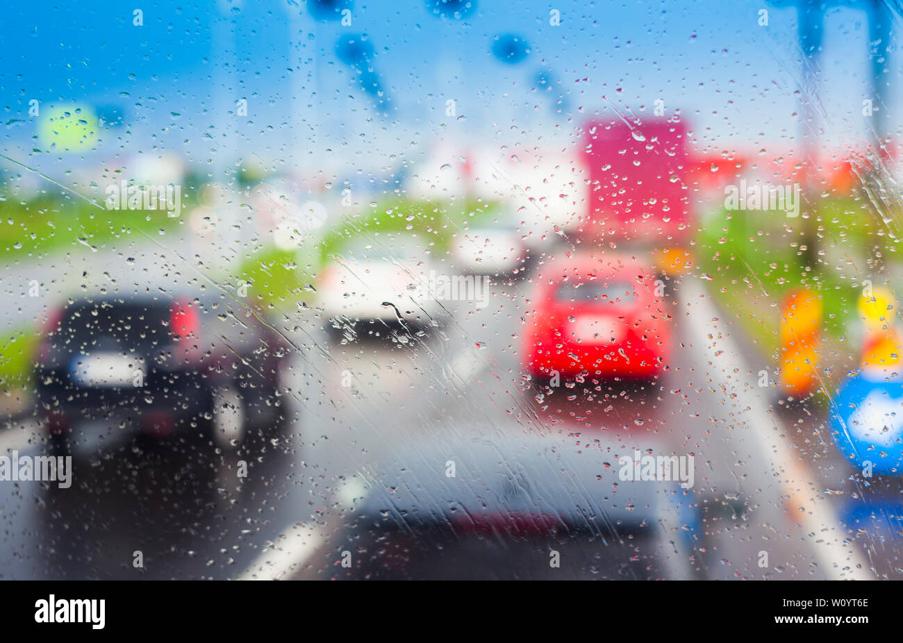 raining on the window of car. cars on the road, transportation concept ...