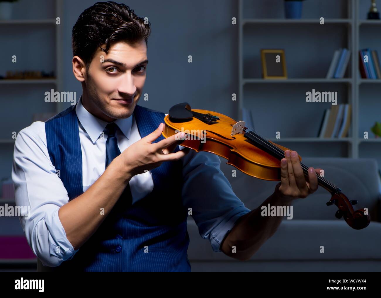 Young musician man practicing playing violin at home Stock Photo - Alamy