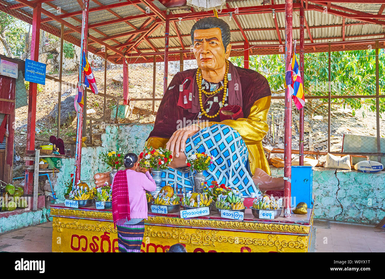 POPA, MYANMAR - FEBRUARY 26, 2018: The Buddhist devotee is making ...