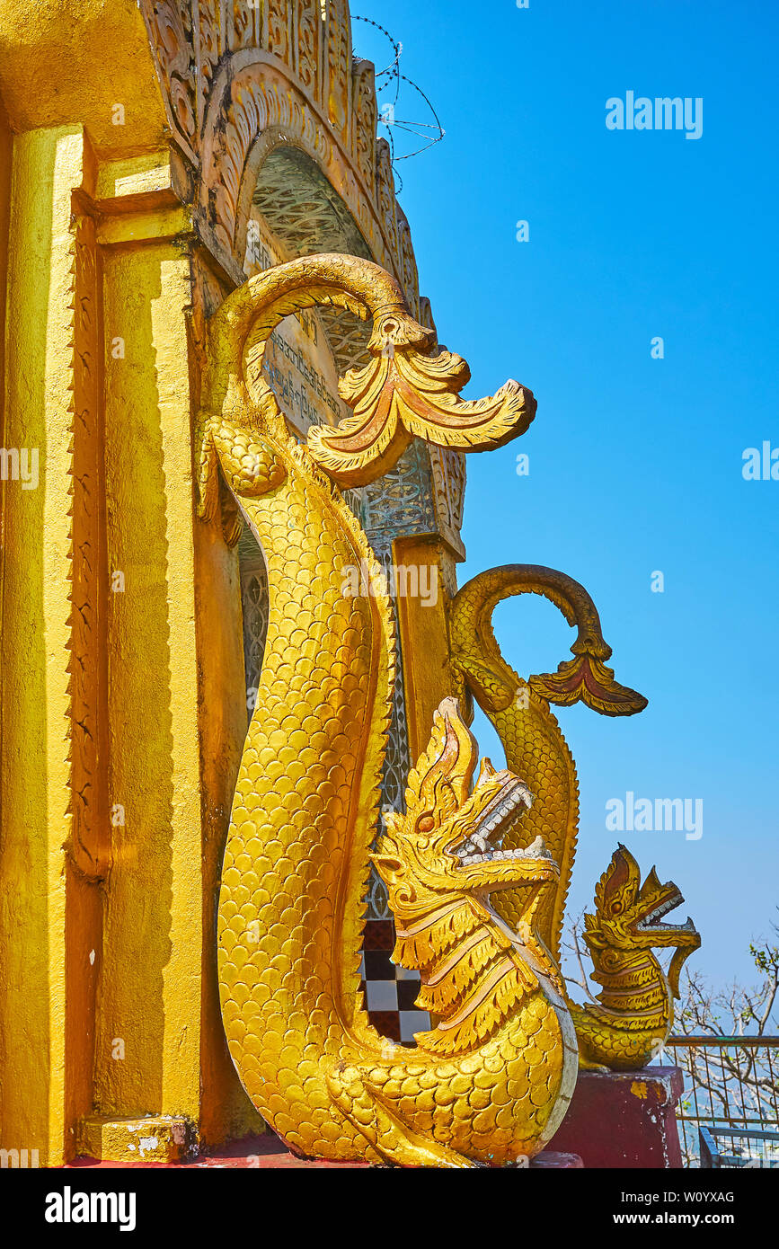 The golden Burmese Nagar dragons guard the stupa of Taung Kalat Temple ...