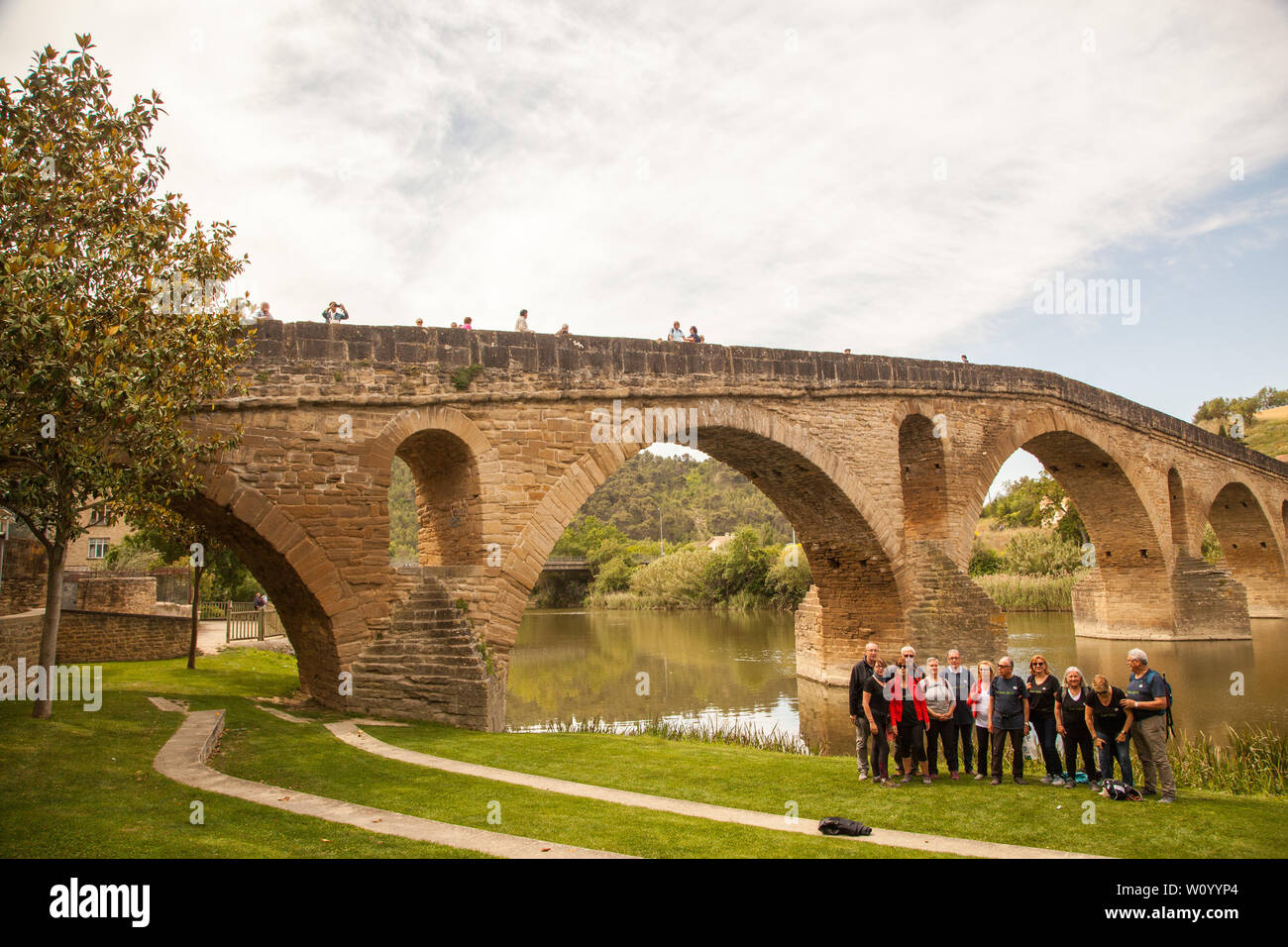 Pilgrims bellow the medieval bridge in the town of Puente la Reina ...
