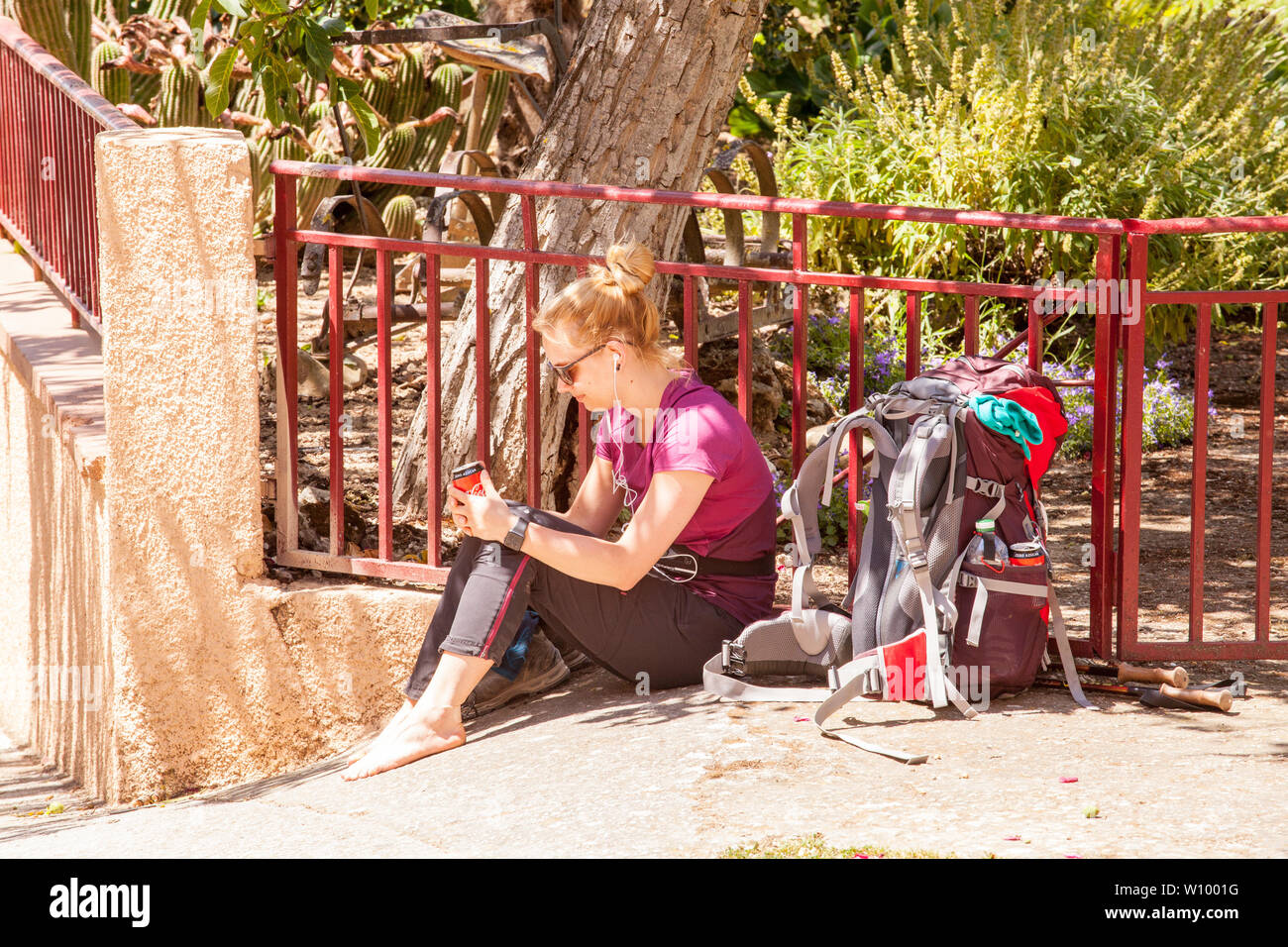 Woman backpacker resting taking a break while walking the Camino de ...