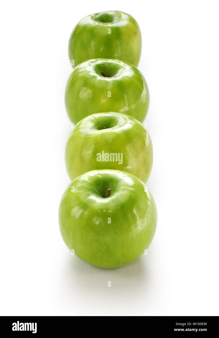 four green apples isolated on white background Stock Photo - Alamy