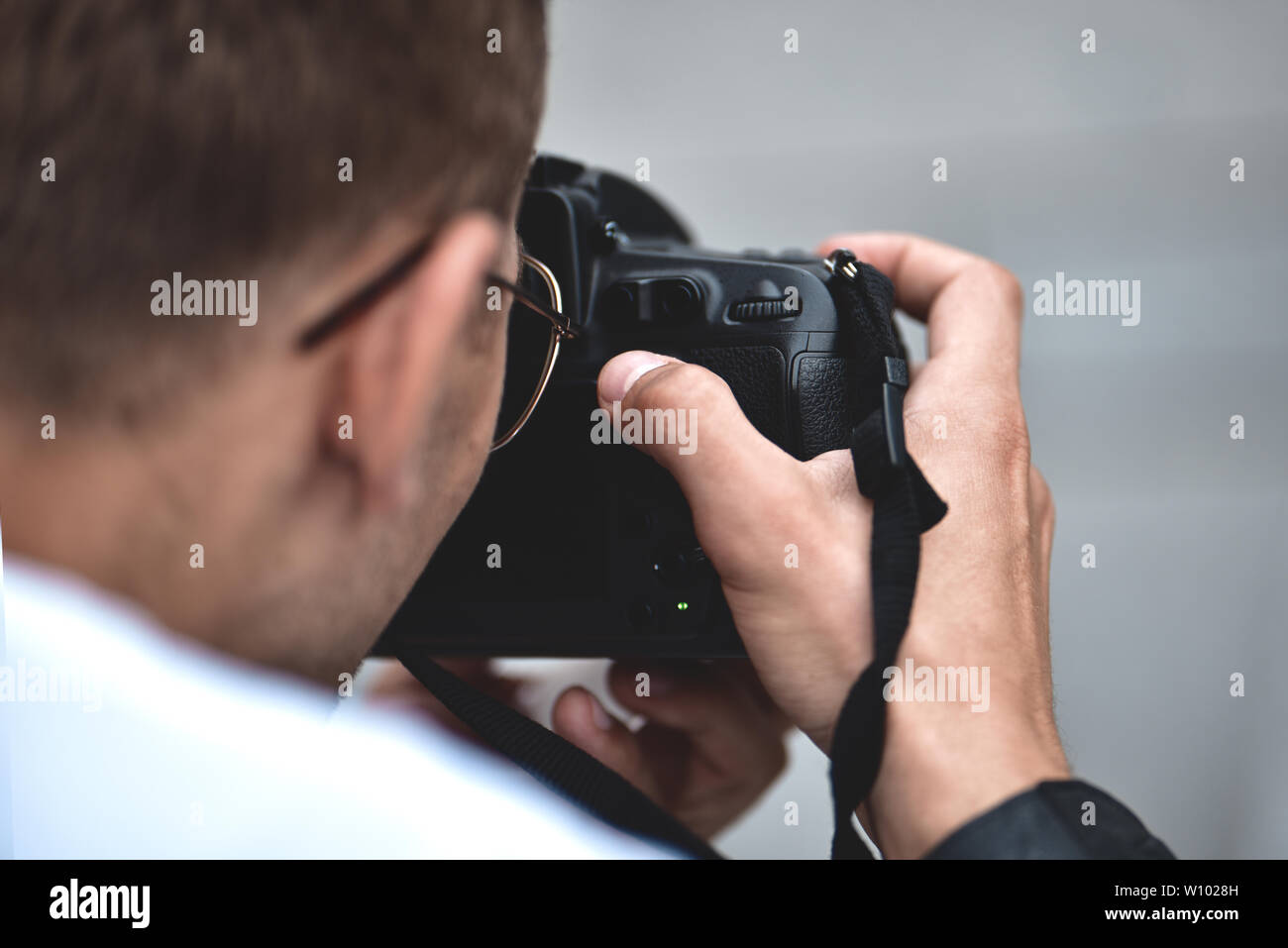 Digital single-lens reflex camera in hands. Photographer shooting hands ...