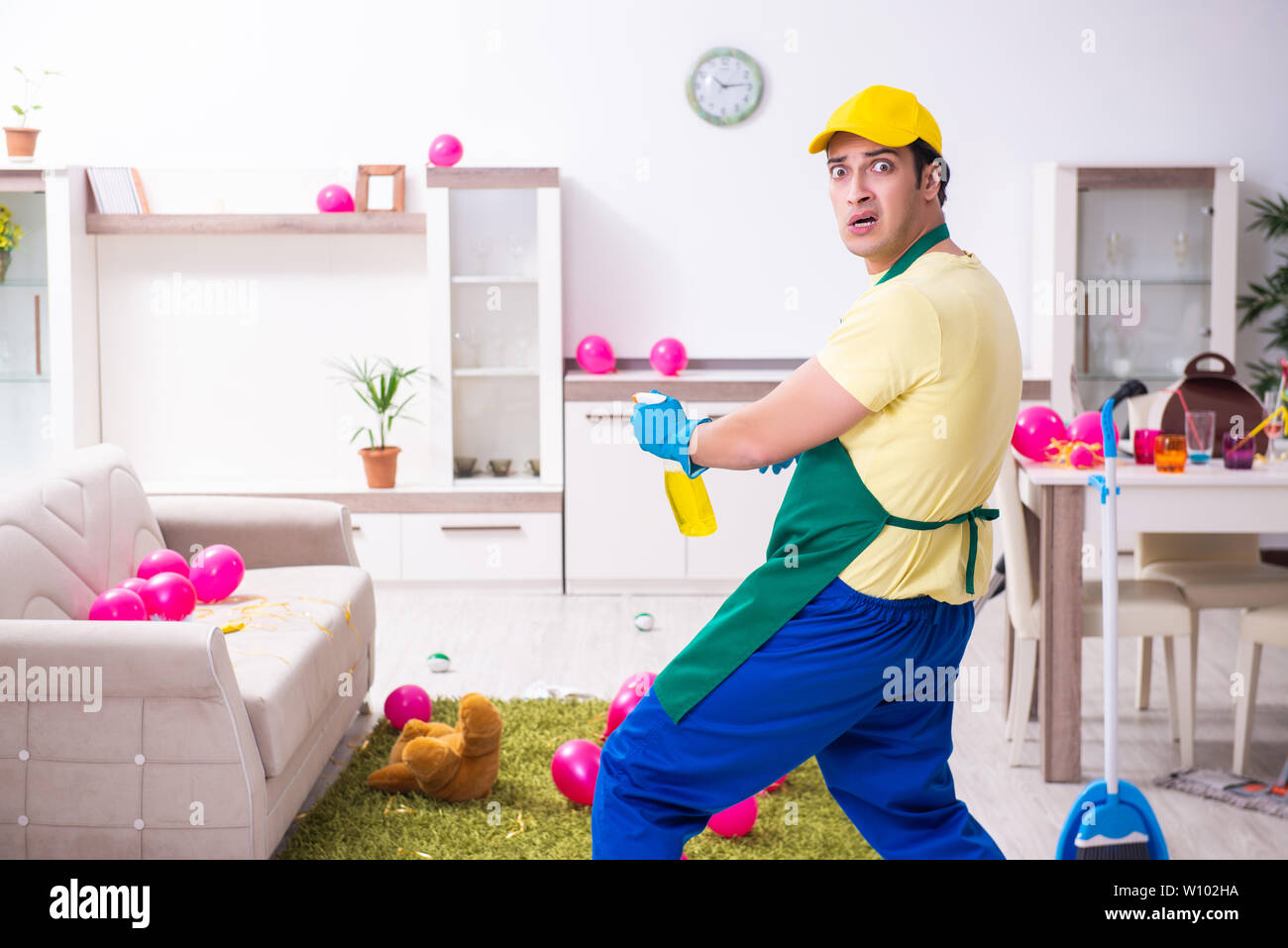 The young male contractor doing housework after party Stock Photo - Alamy