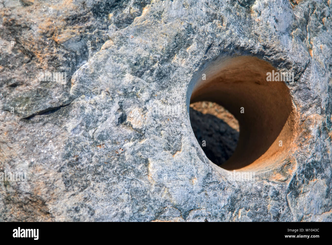 The texture of a large natural stone with a through hole close-up Stock ...