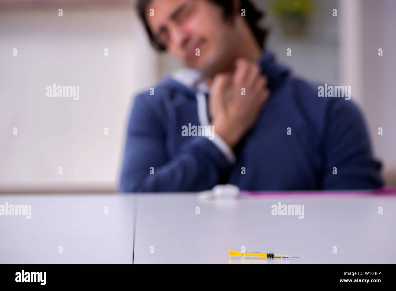 Young man having problems with narcotics at home hi-res stock ...