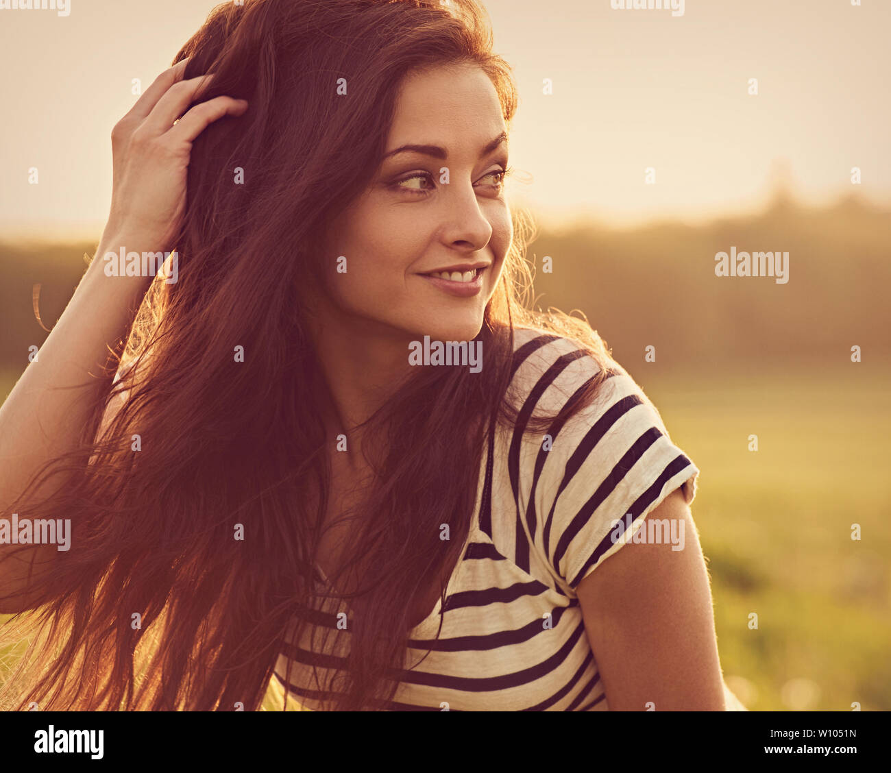 Beautiful thinking smiling young woman looking happy with long bright ...