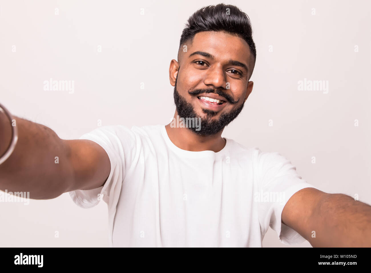 Young indian man taking selfie isolated on white background Stock Photo ...