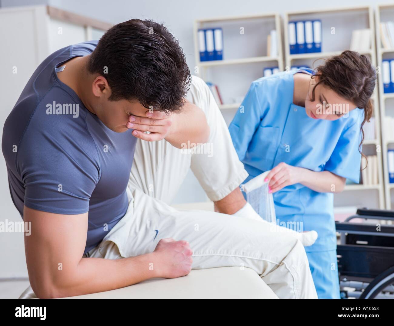 Doctor and patient during check-up for injury in hospital Stock Photo ...