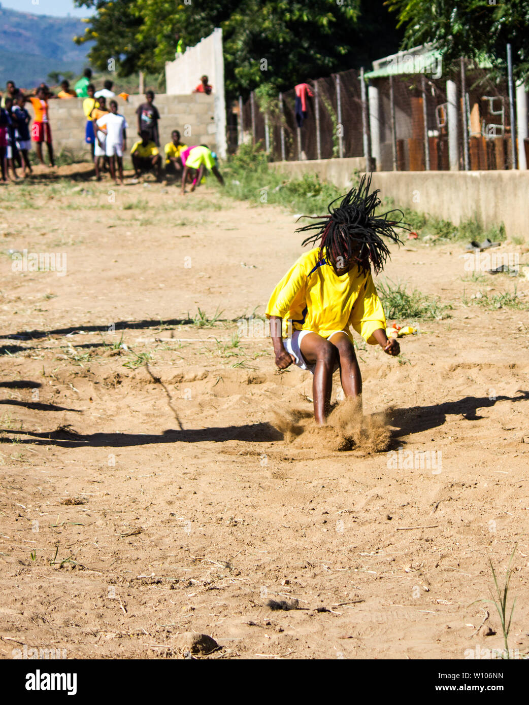High school girl landing after a long jump during their local physical ...