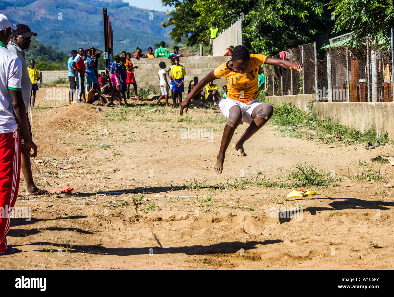 High school girl landing after a long jump during their local physical ...