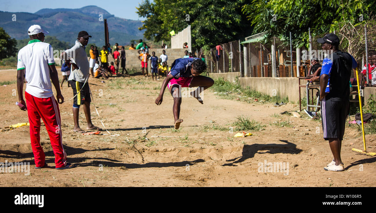 High school girl landing after a long jump during their local physical ...