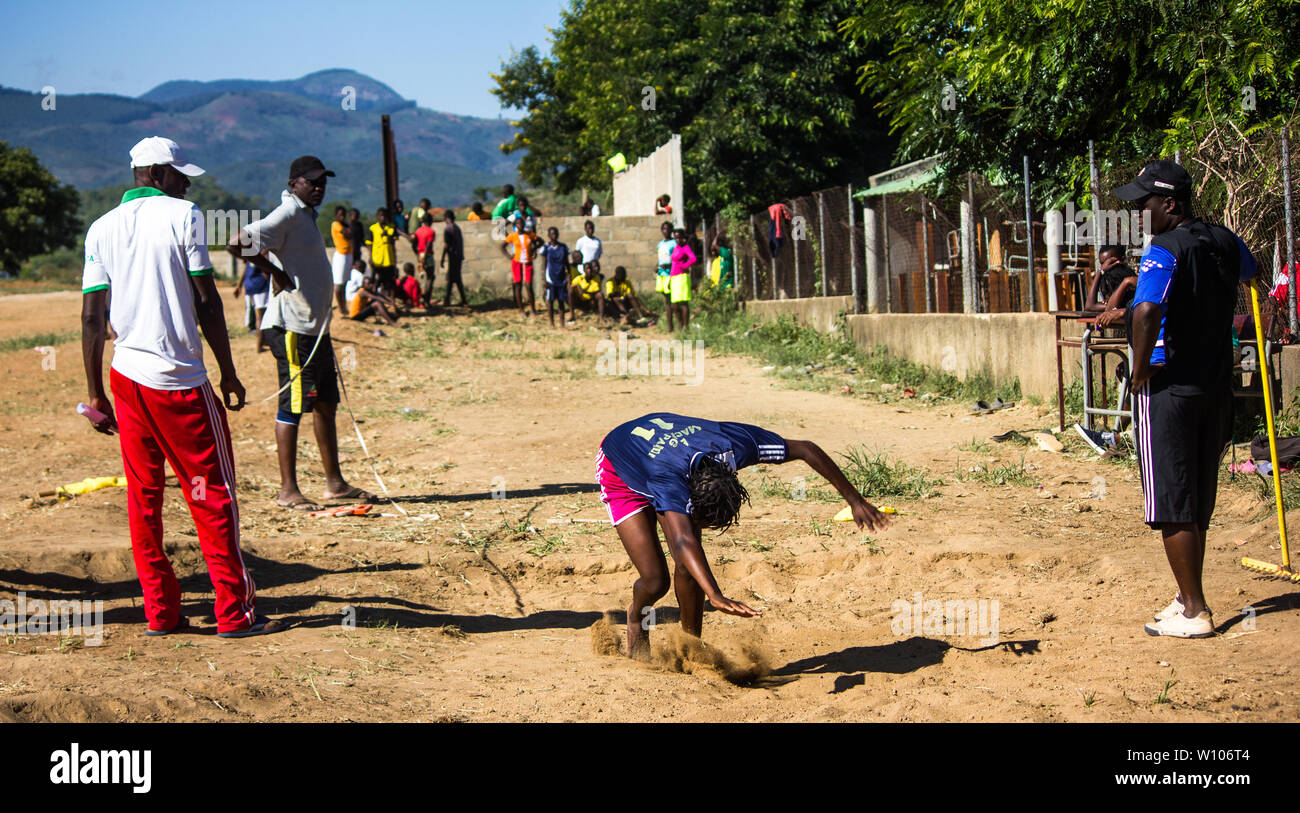 High school girl landing after a long jump during their local physical ...