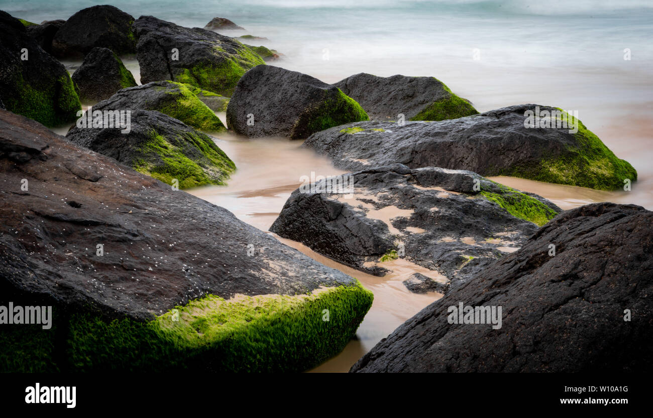 Black rocks at Point Danger in NSW Australia Stock Photo - Alamy