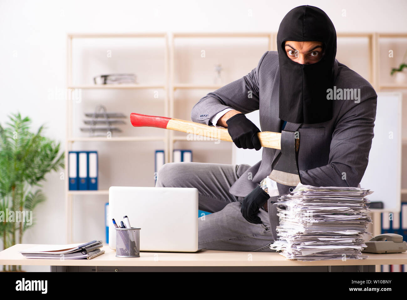 Male gangster stealing information from the office Stock Photo - Alamy