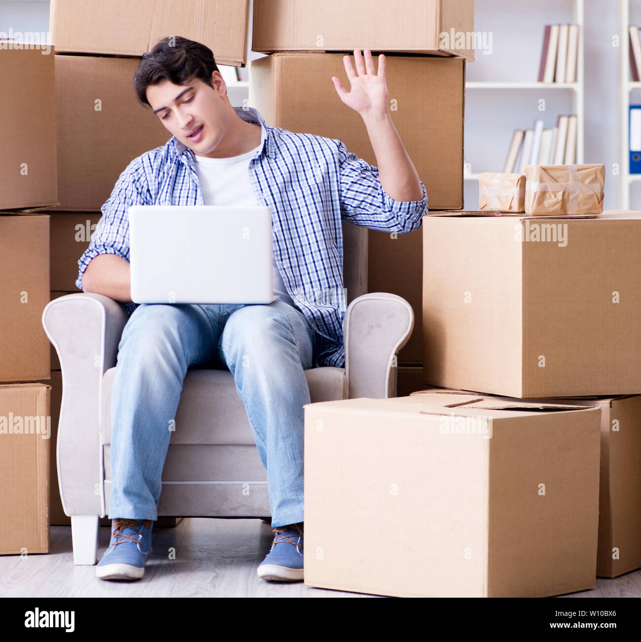 Young man moving in to new house with boxes Stock Photo - Alamy
