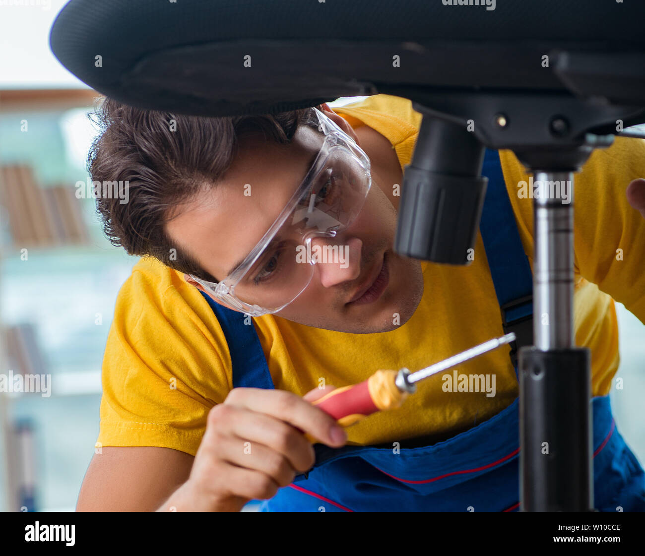 Furniture repairman working on repairing the chair Stock Photo - Alamy