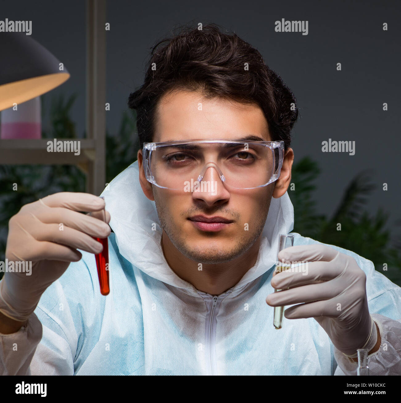 Young male doctor doing blood test late at night in overtime time Stock ...