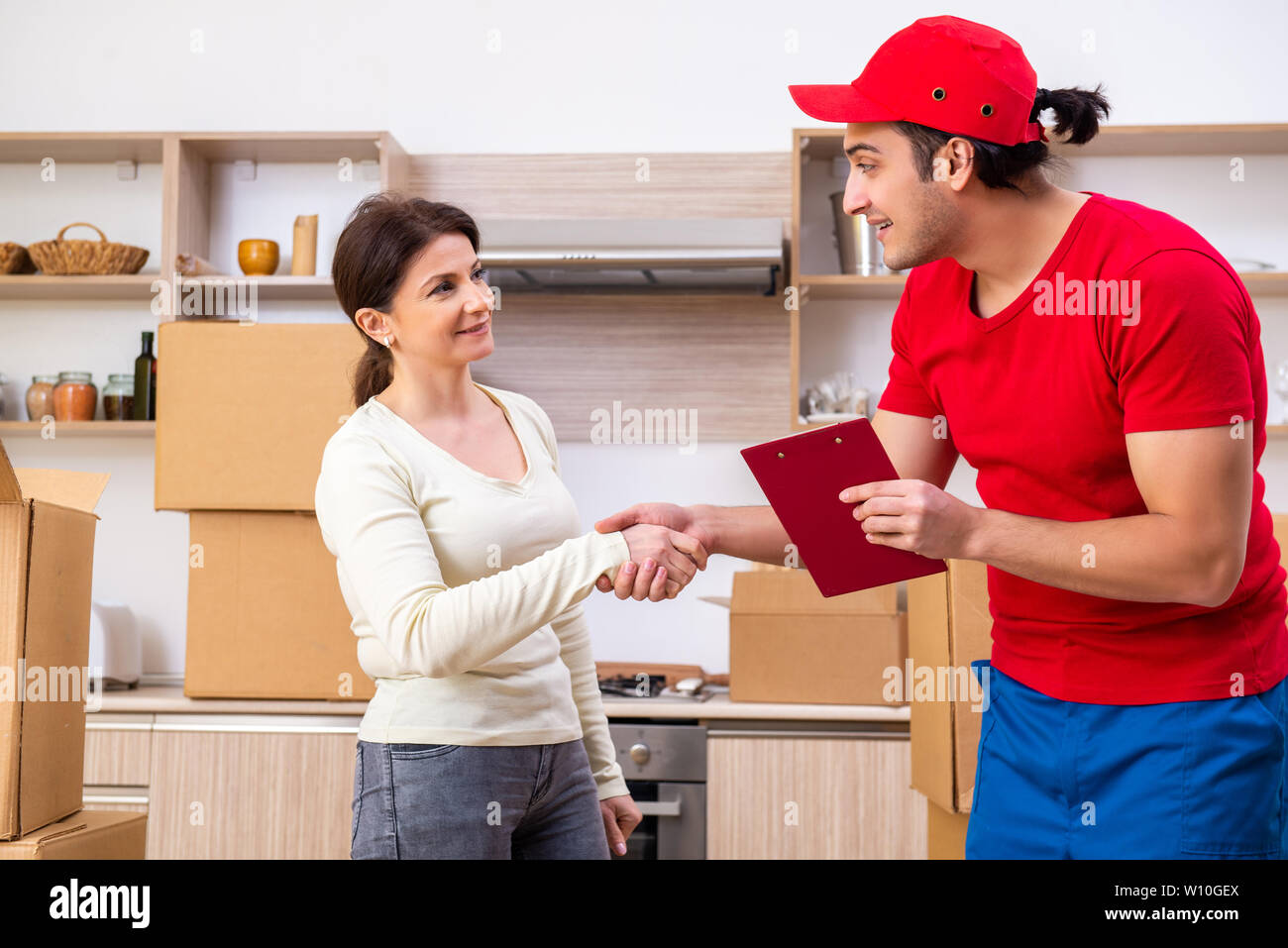 Young male contractor and female customer in moving concept Stock Photo ...