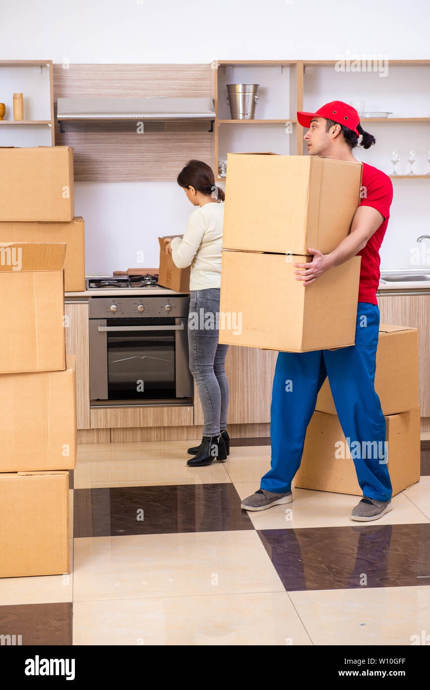 Young male contractor and female customer in moving concept Stock Photo ...