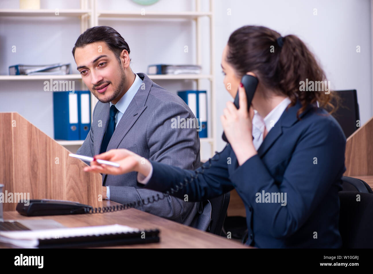 Two employees working in the office Stock Photo - Alamy