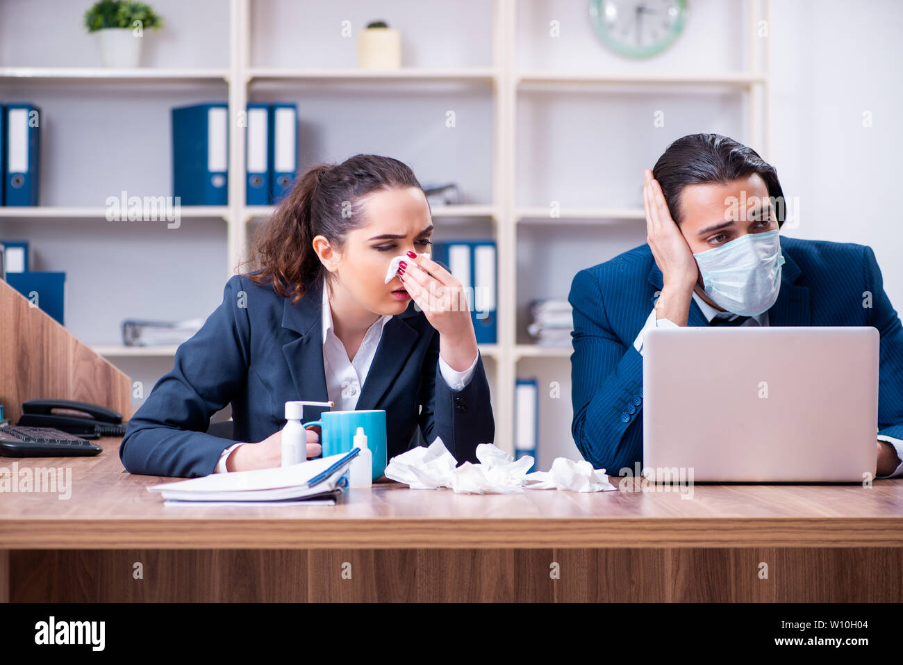 Two employees suffering at workplace Stock Photo - Alamy
