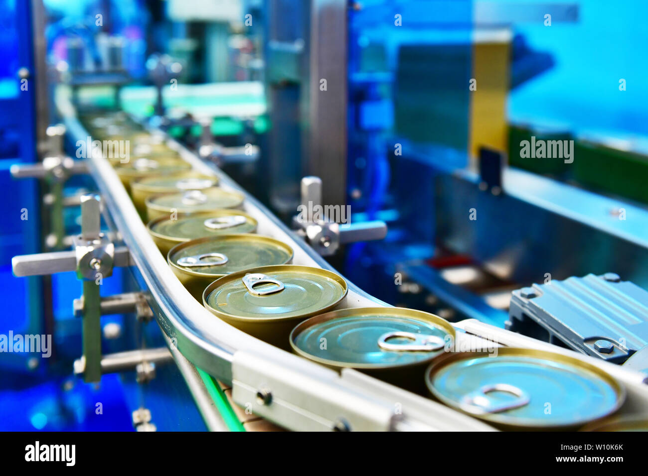 Canned food products on conveyor belt in distribution warehouse.parcels ...